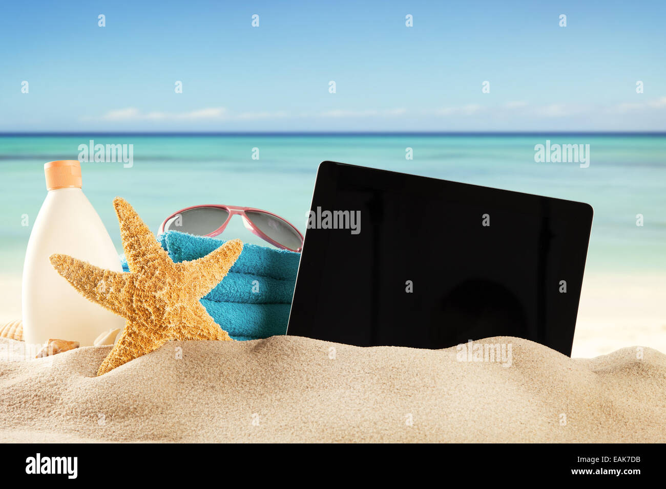Concept with summer beach, tablet and accessories, blur sea on ...
