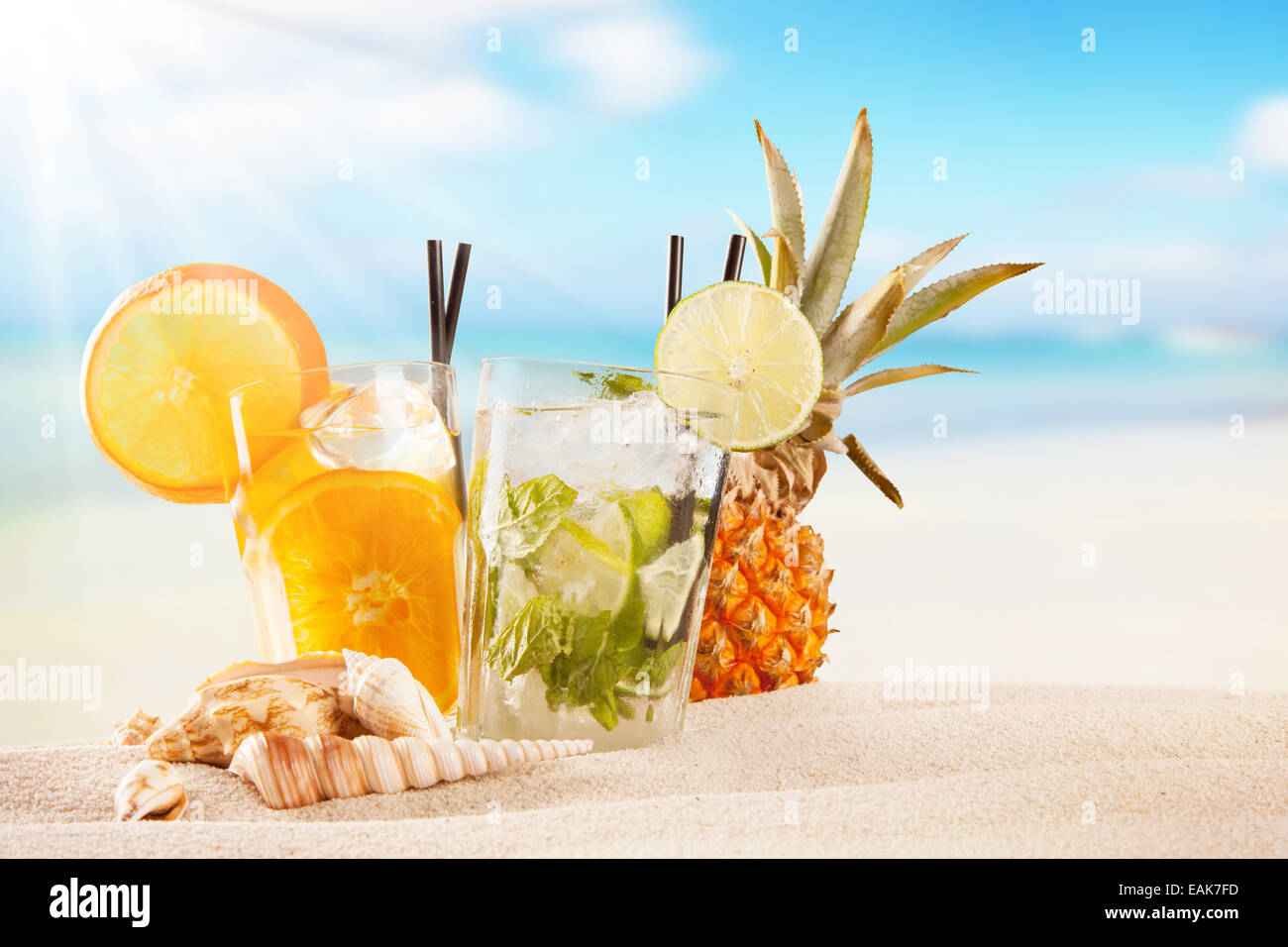 Exotic summer drinks in sand. Blur beach as background Stock Photo - Alamy