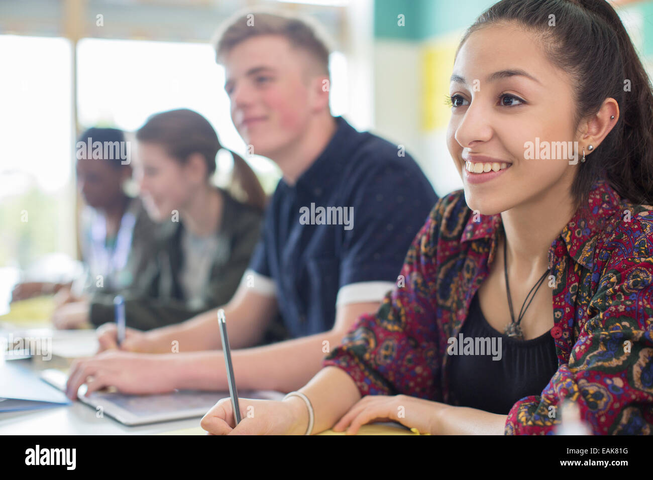 Students in classroom smiling during lesson Stock Photo - Alamy