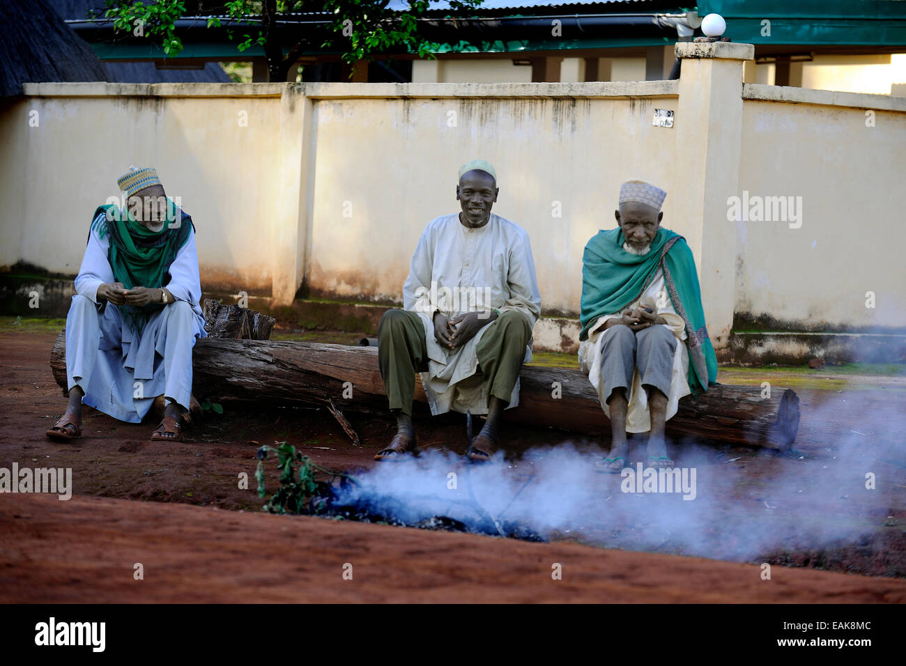 Three men sitting on the roadside in the village of Idool and ...