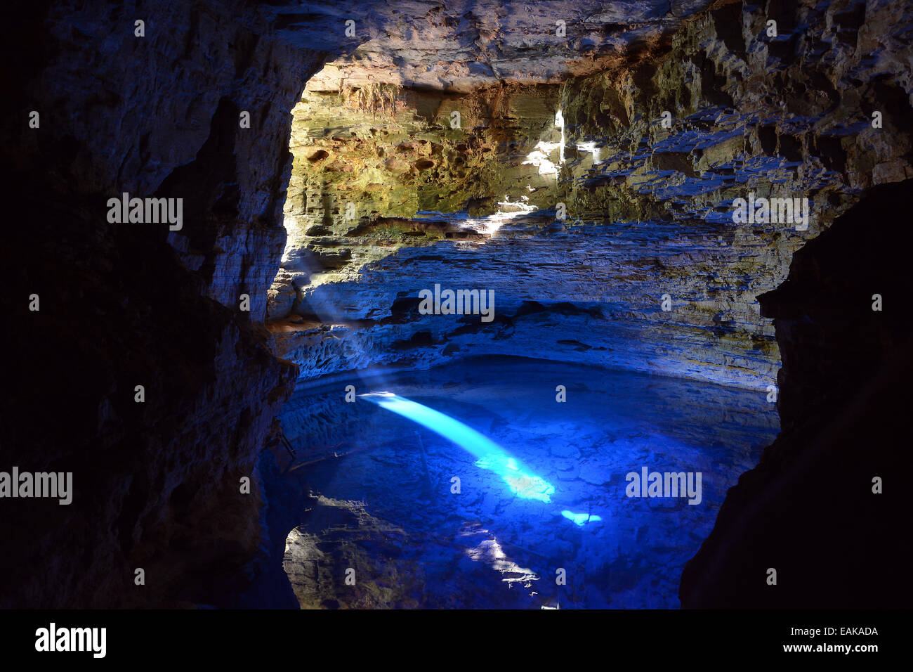 The colorful cave Poco Encantado with rays of light, Chapada Diamantina ...