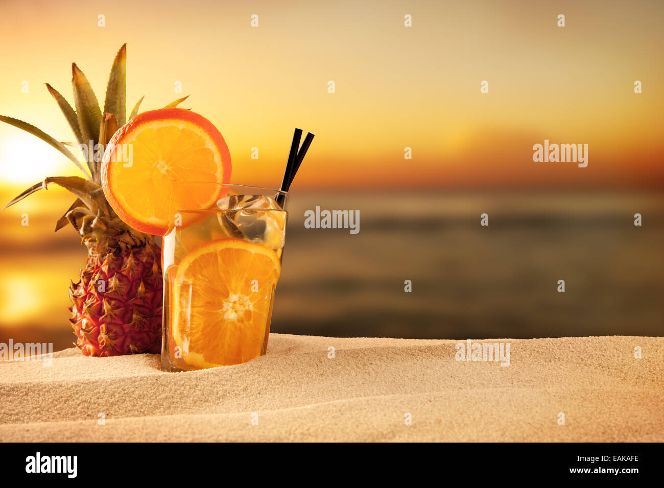 Exotic summer drink with sea shells, blur sandy beach on background ...