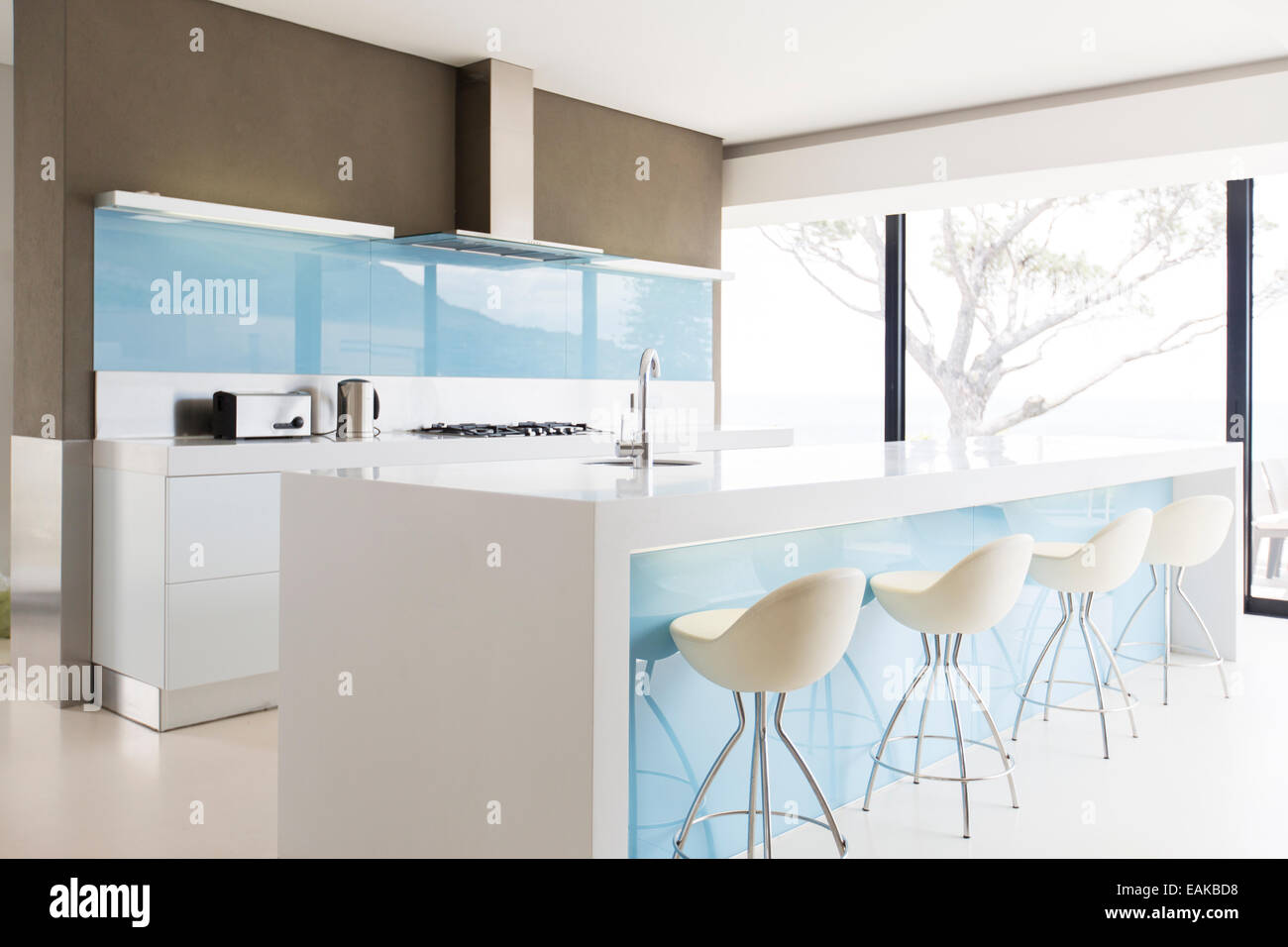 White and clean modern kitchen with stools at kitchen island Stock ...
