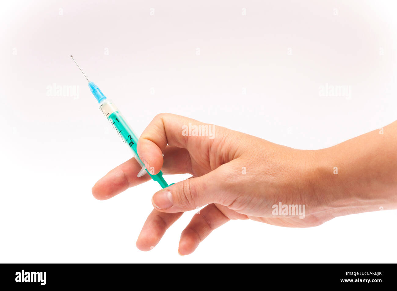Syringe in hand on white background Stock Photo - Alamy