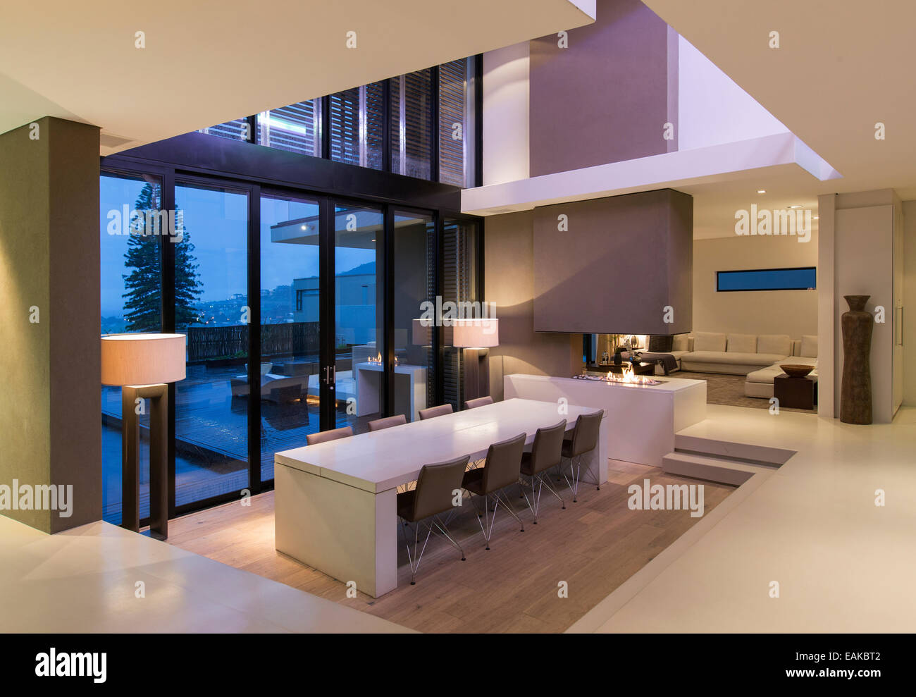 View of modern dining room with large table and chairs at night Stock ...