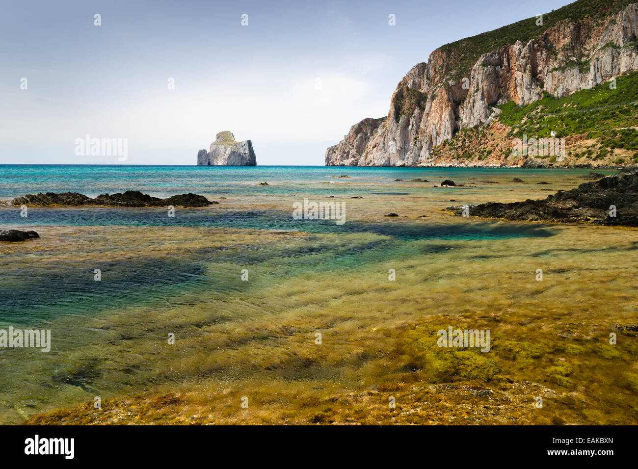 Spiaggia di Masua bay with the Pan di Zuccherof rock island in the sea ...