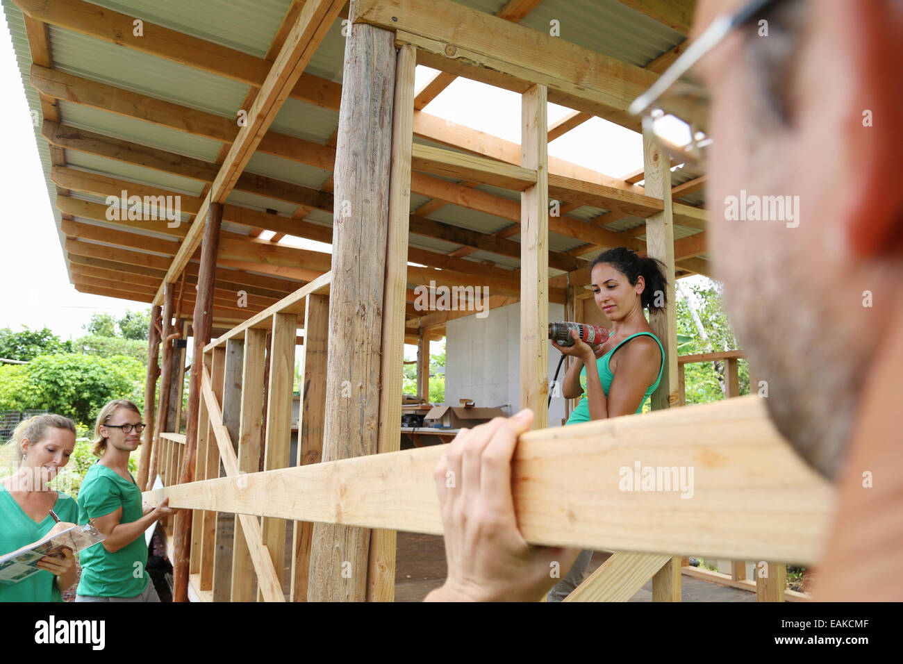 People building wooden house frame together Stock Photo - Alamy