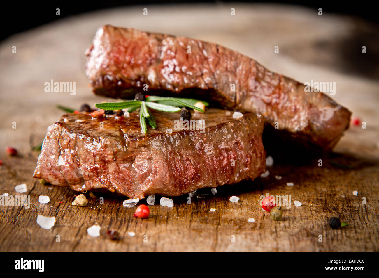 Delicious beef steaks on wood Stock Photo - Alamy