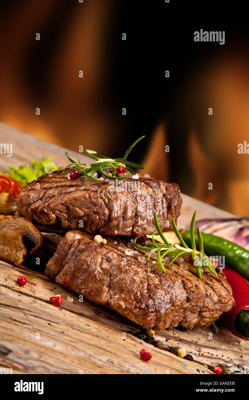 Delicious beef steakes on wood Stock Photo - Alamy