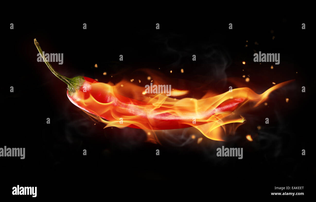 Burning red chilli pepper isolated on black background Stock Photo - Alamy
