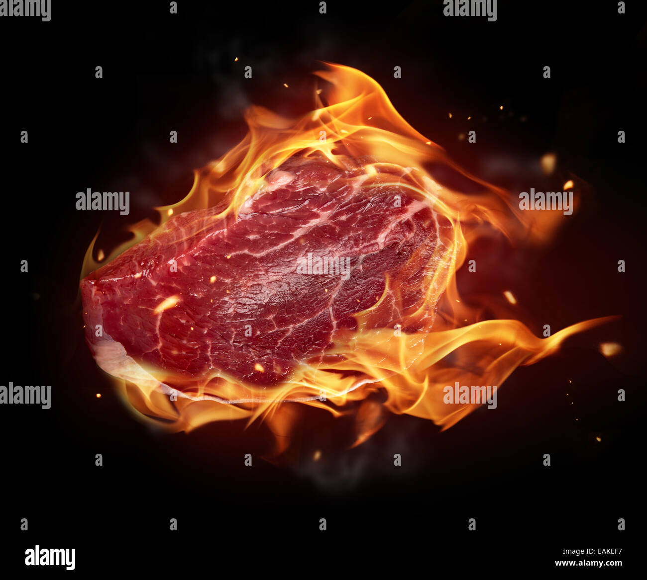 Concept of burning raw beef steak isolated on black background Stock ...