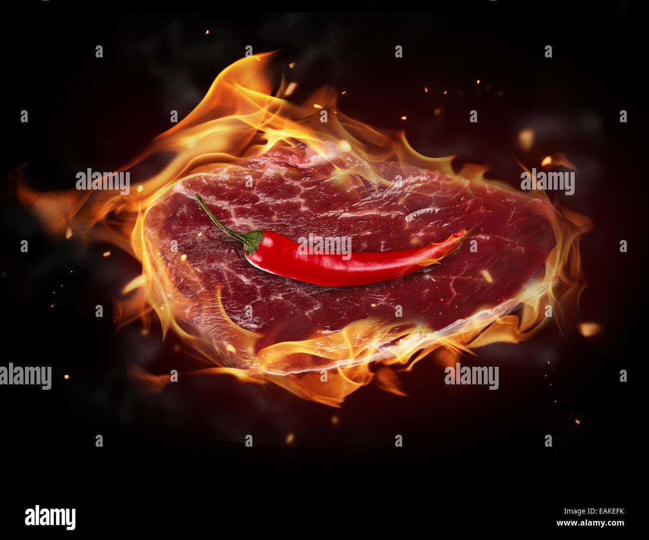 Concept of burning raw beef steak isolated on black background Stock ...