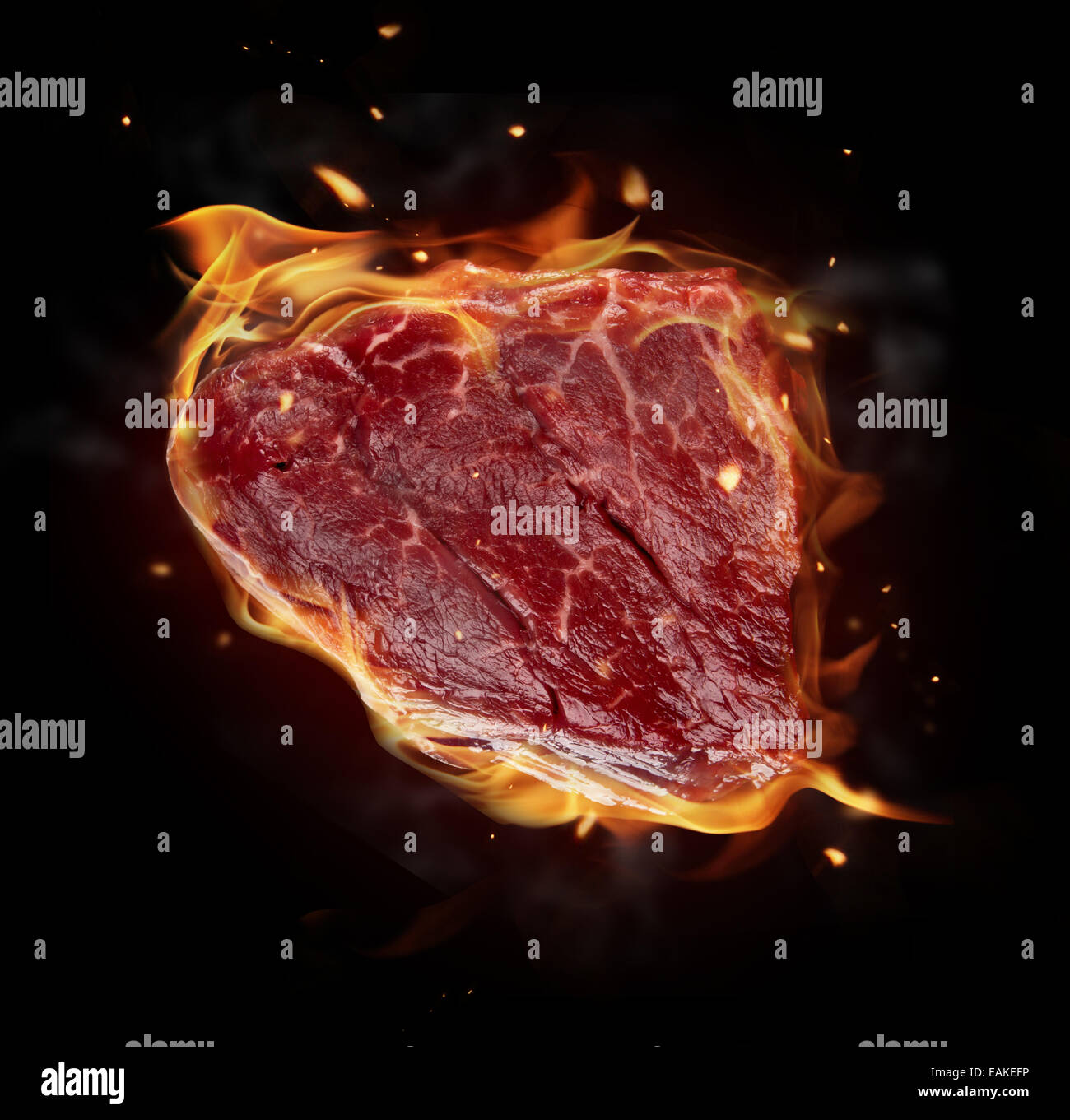 Concept of burning raw beef steak isolated on black background Stock ...