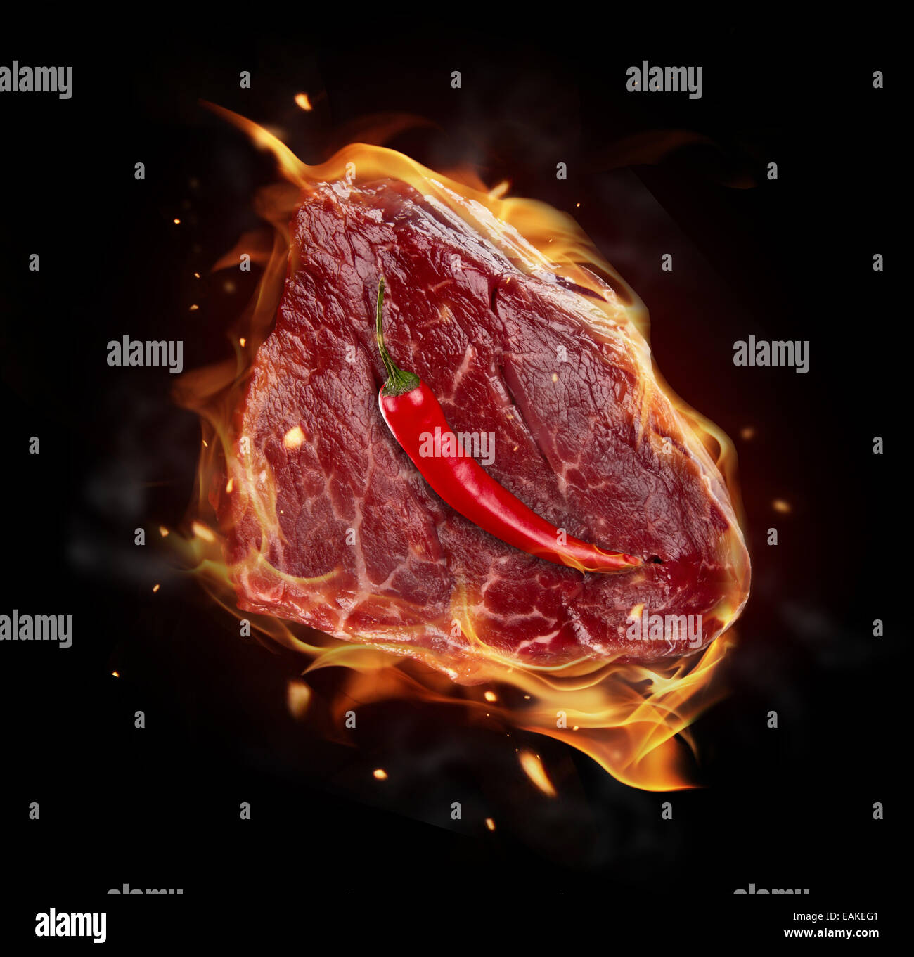 Concept of burning raw beef steak isolated on black background Stock ...