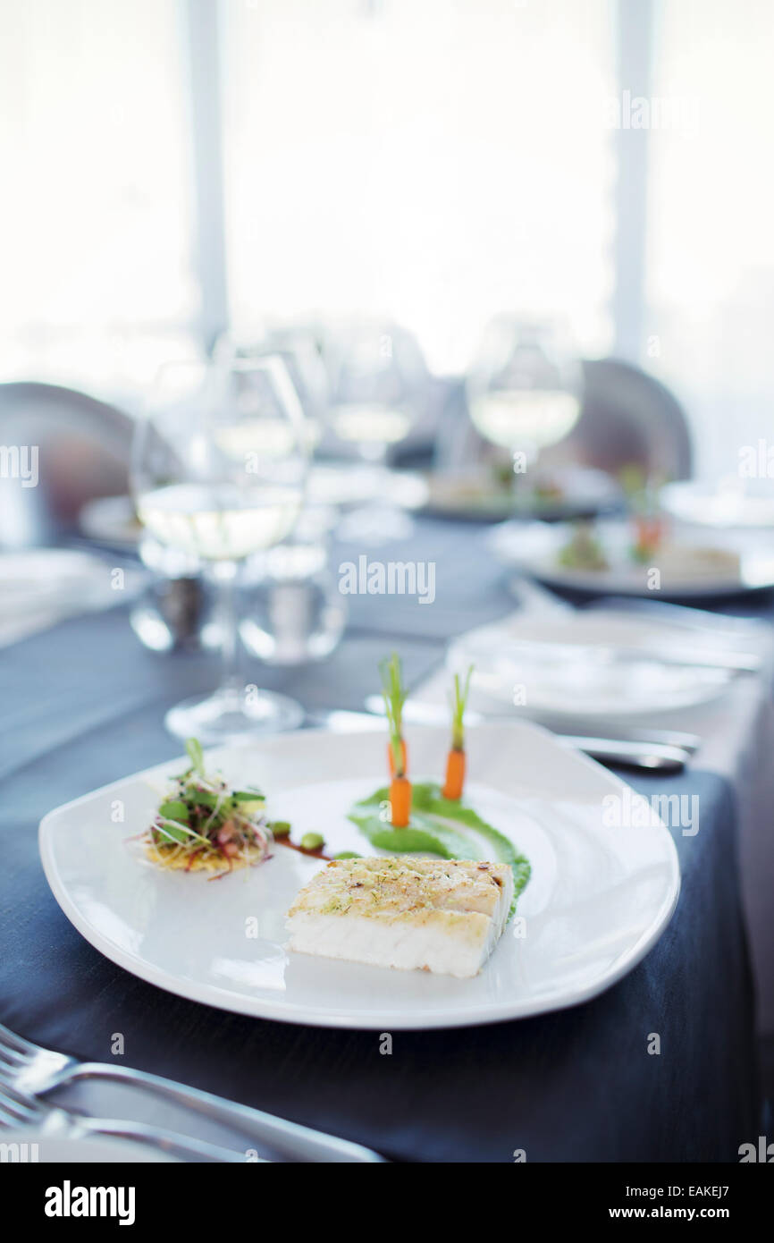 Fancy fish meal on plate in restaurant Stock Photo - Alamy