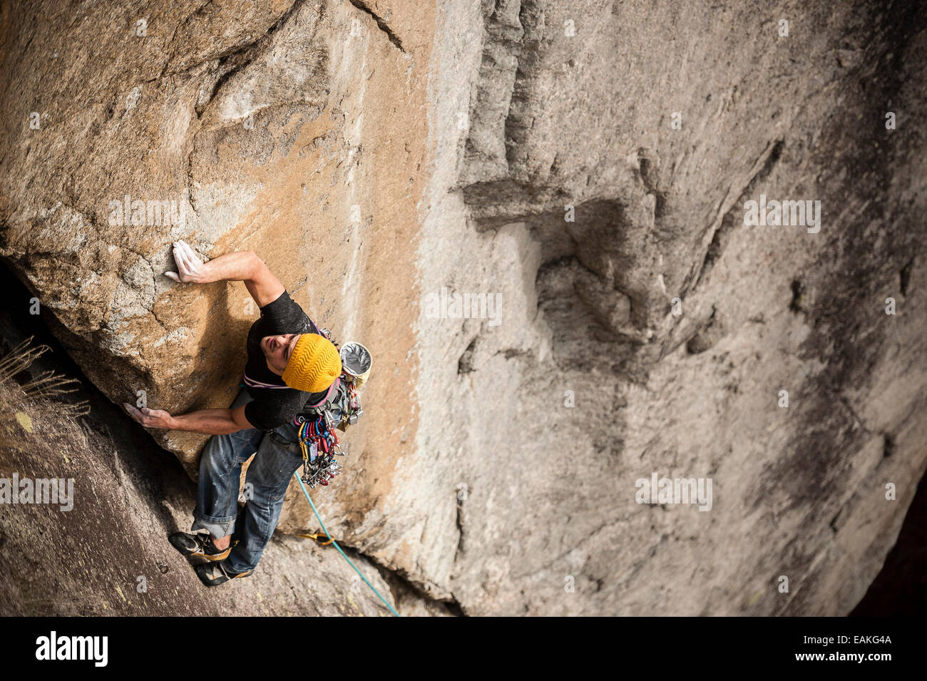 Man lead climbing a two pitches crack route in trad style (that means ...