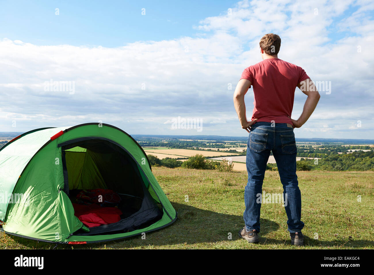 Rear View Of Man Camping And Admiring View Stock Photo - Alamy
