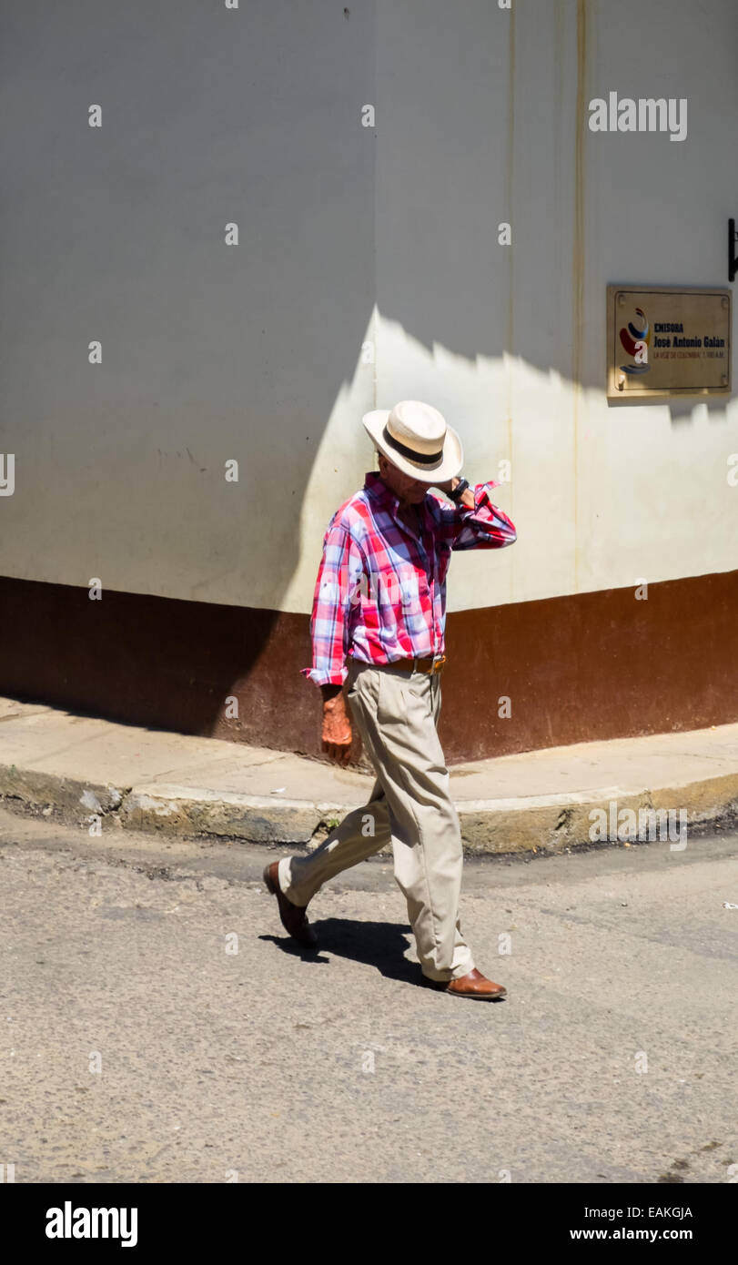 Man with hat walking Stock Photo - Alamy