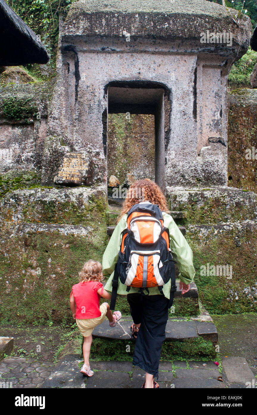 A tourist gazes at the huge shrines carved out of the cliff-face at the ...