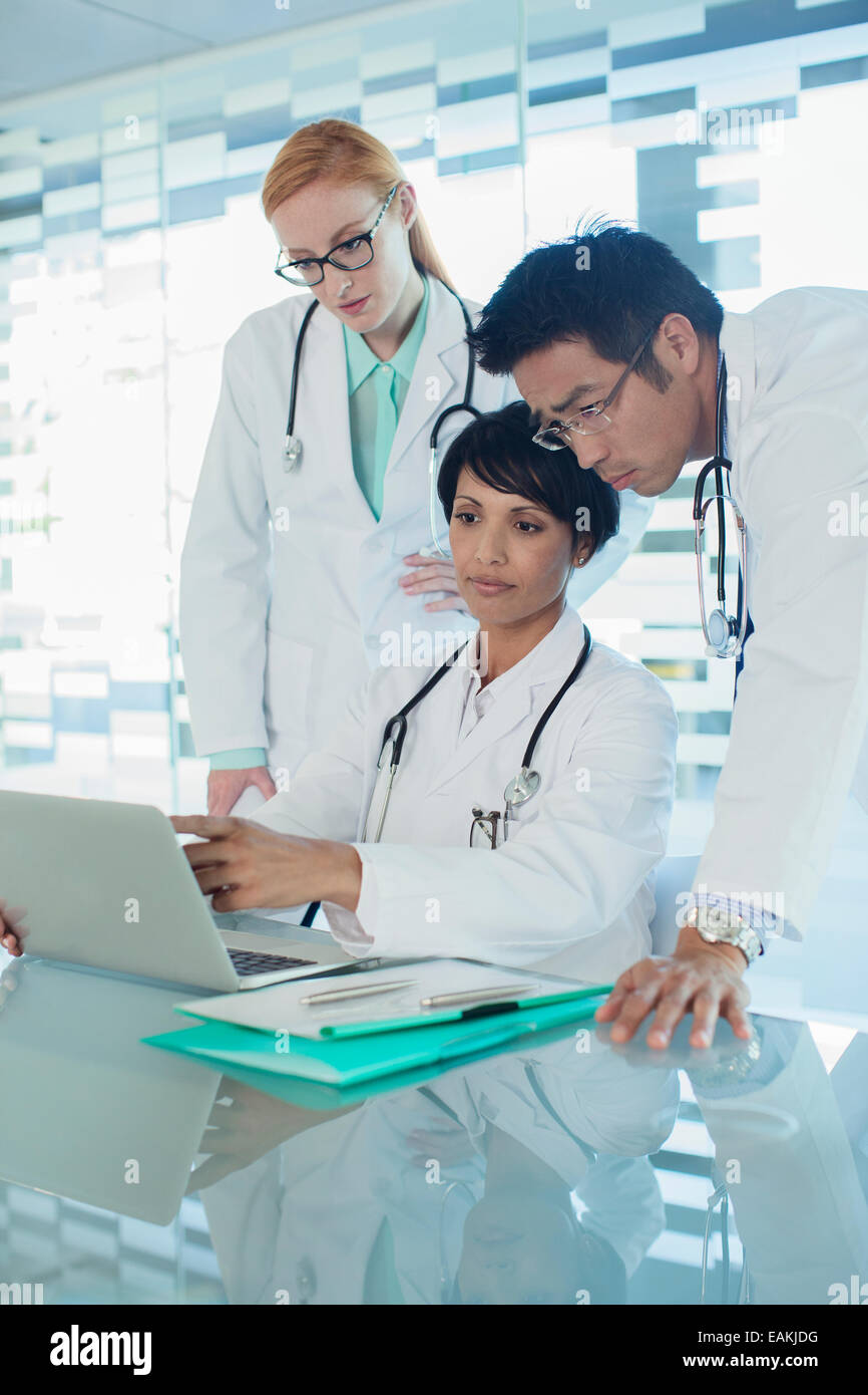 Doctors using laptop and discussing patient's treatment Stock Photo - Alamy