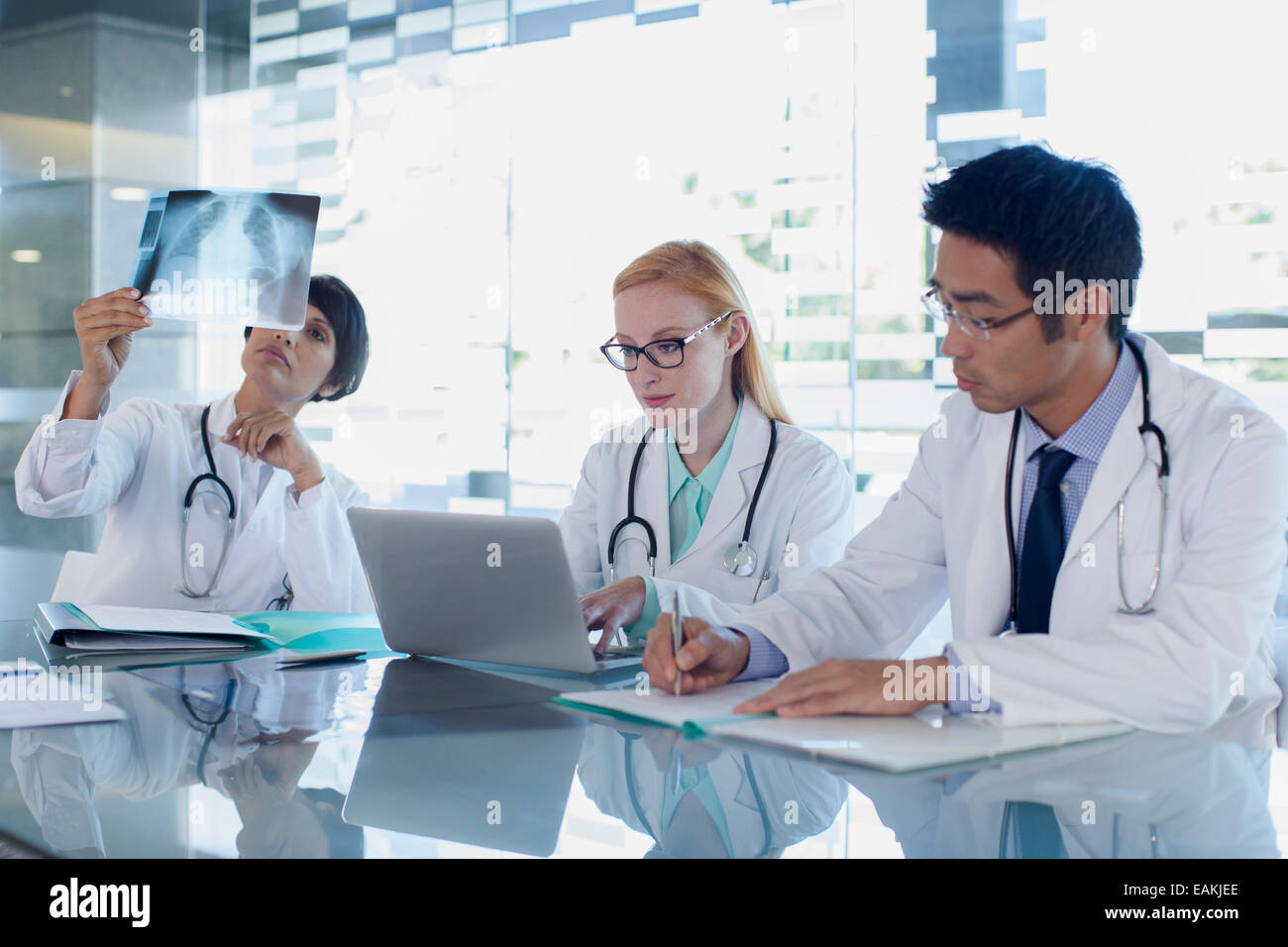 Doctors using laptop and watching patient's x-ray Stock Photo - Alamy