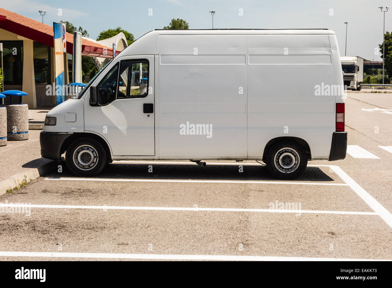 a white van parked in a parking lot Stock Photo - Alamy