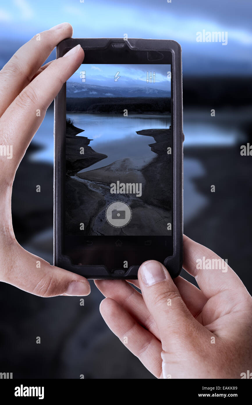 a mobile phone snapping a picture of a gloomy lake Stock Photo - Alamy