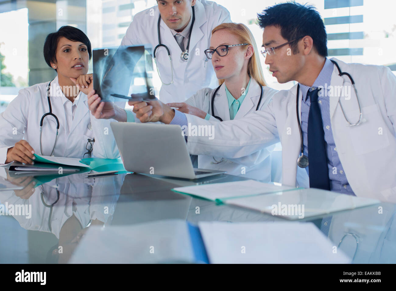 Doctors using laptop and watching patient's x-ray Stock Photo - Alamy
