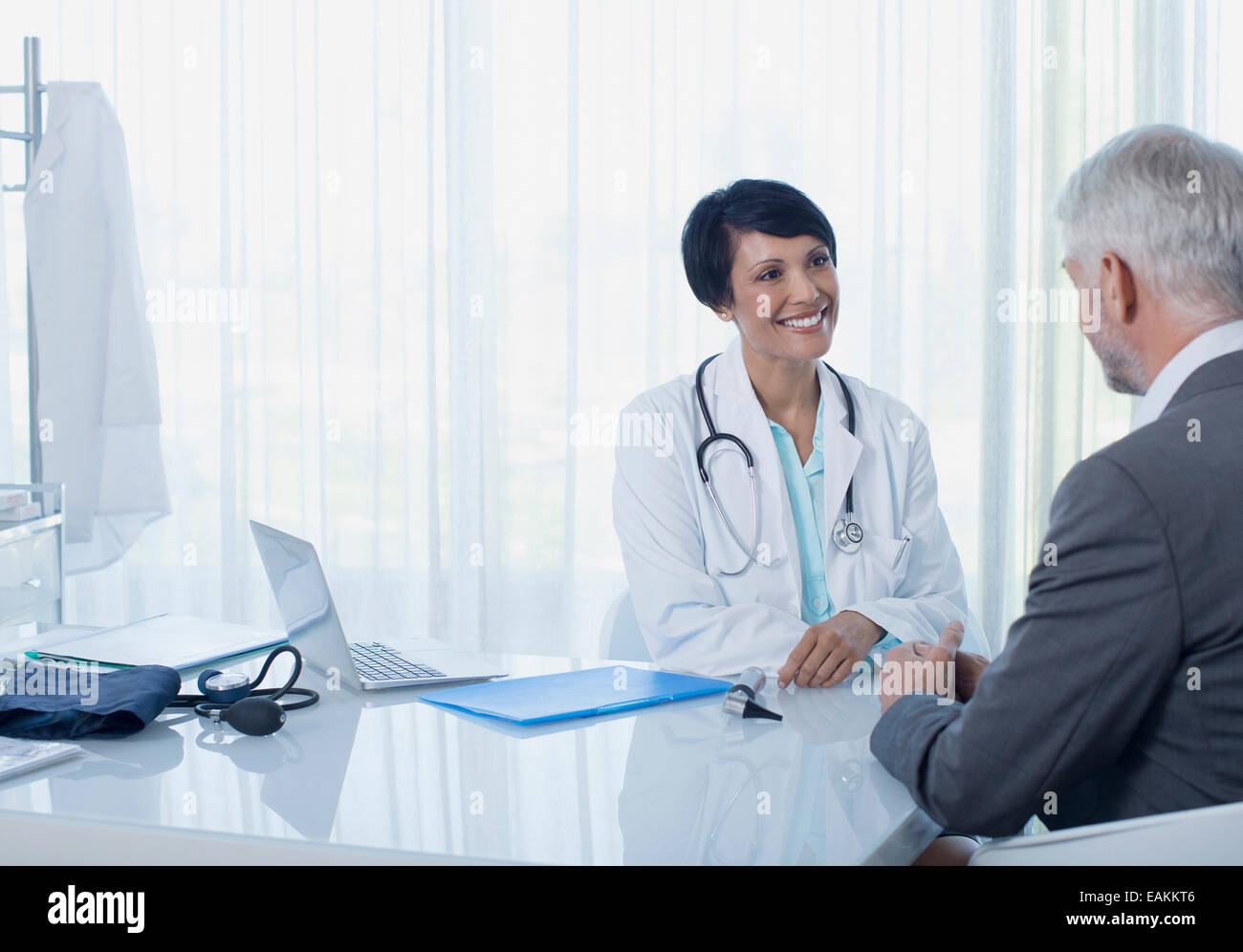 Doctor patient hands table hi-res stock photography and images - Alamy