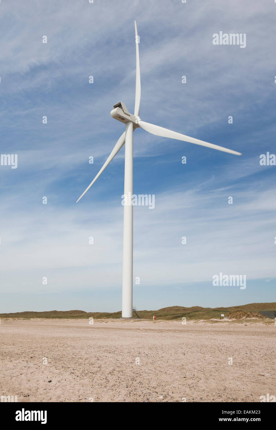 a large windmill to generate electricity by the sandy beach Stock Photo ...