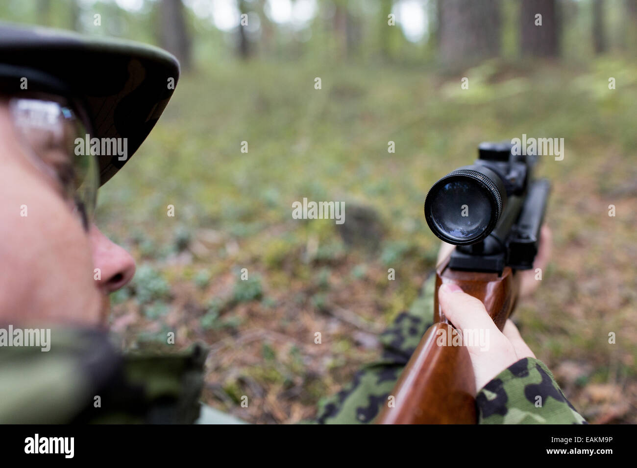 close up of soldier or hunter with gun in forest Stock Photo - Alamy