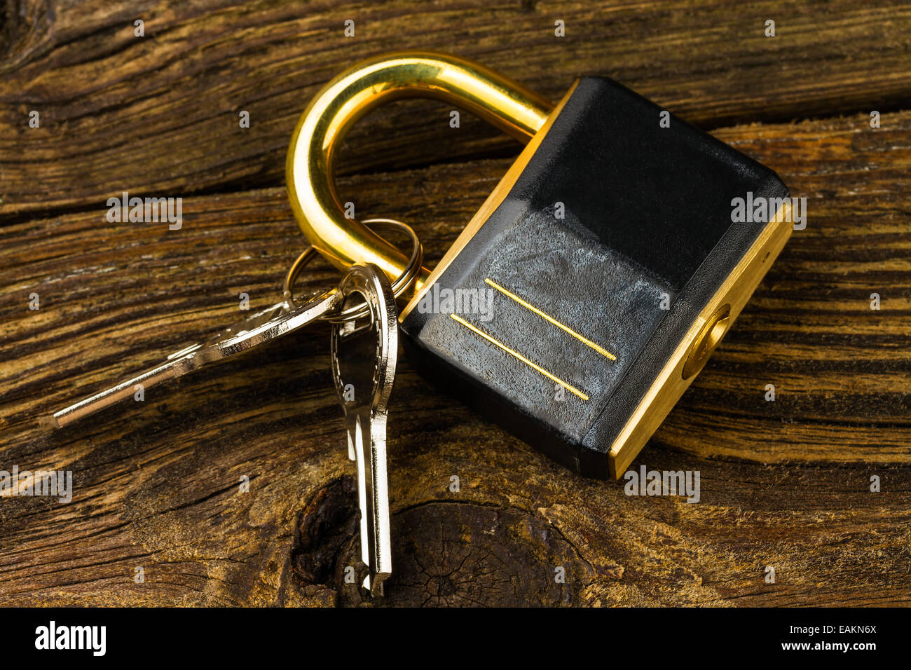 hinged lock with keys on wooden background Stock Photo - Alamy