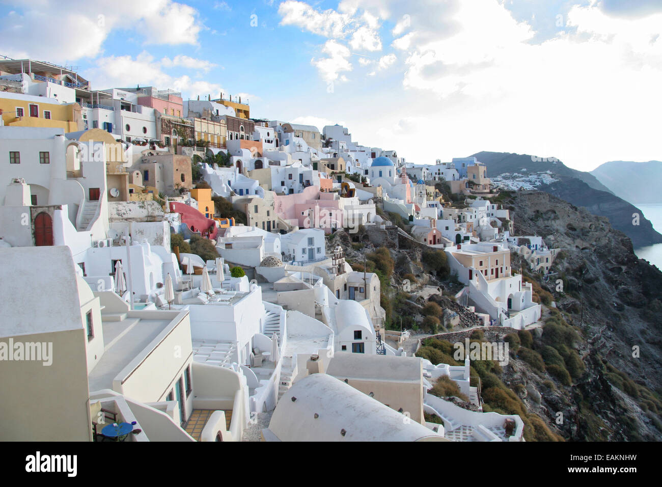 Oia town with traditional buildings painted white on the cliff side ...