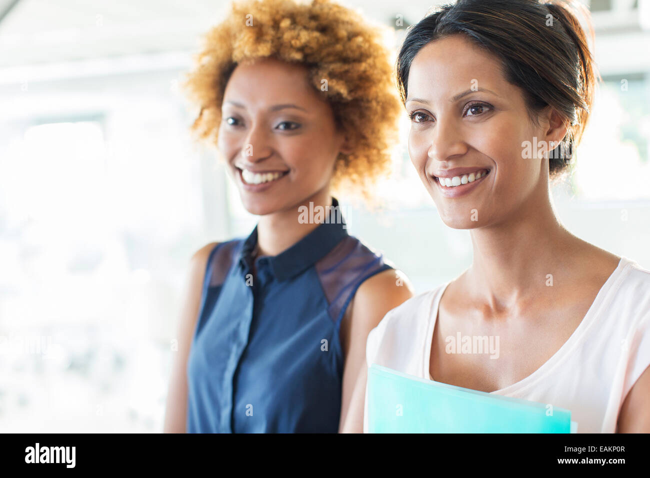 Portrait of two smiling businesswomen in office Stock Photo - Alamy