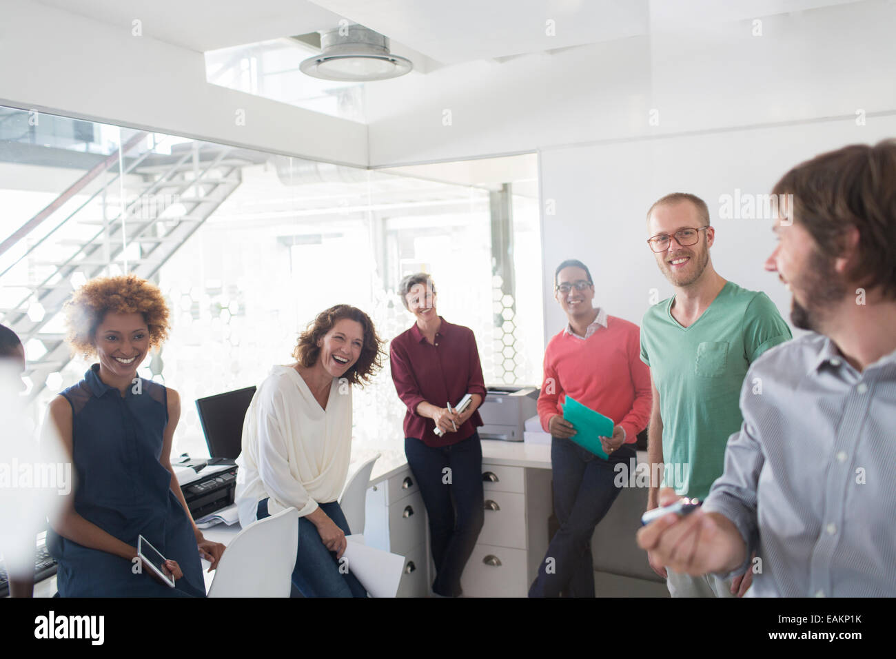 Smiling team having meeting in modern office Stock Photo - Alamy