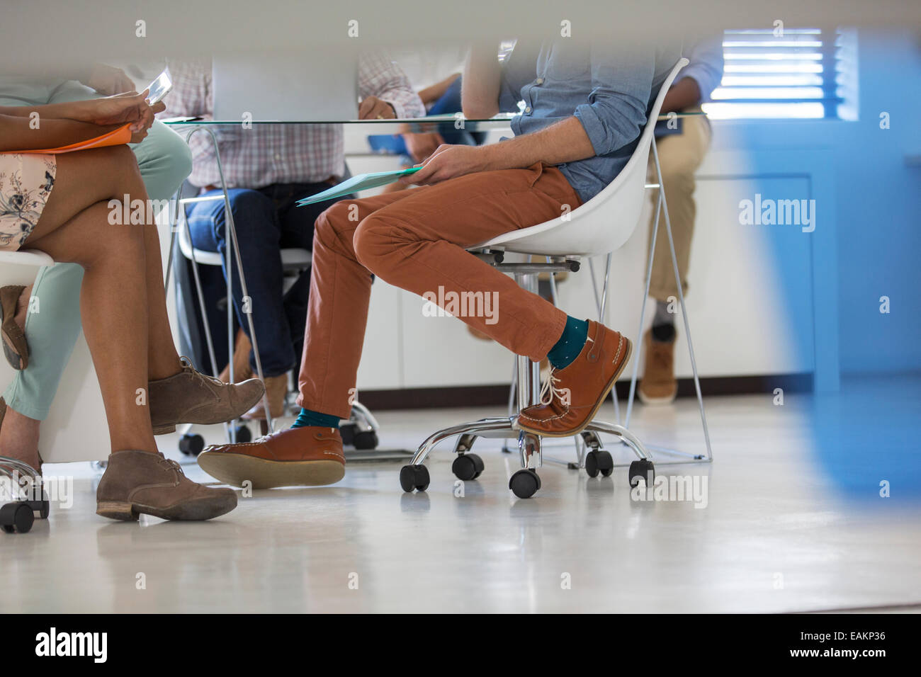 Low section of people having meeting in office Stock Photo - Alamy