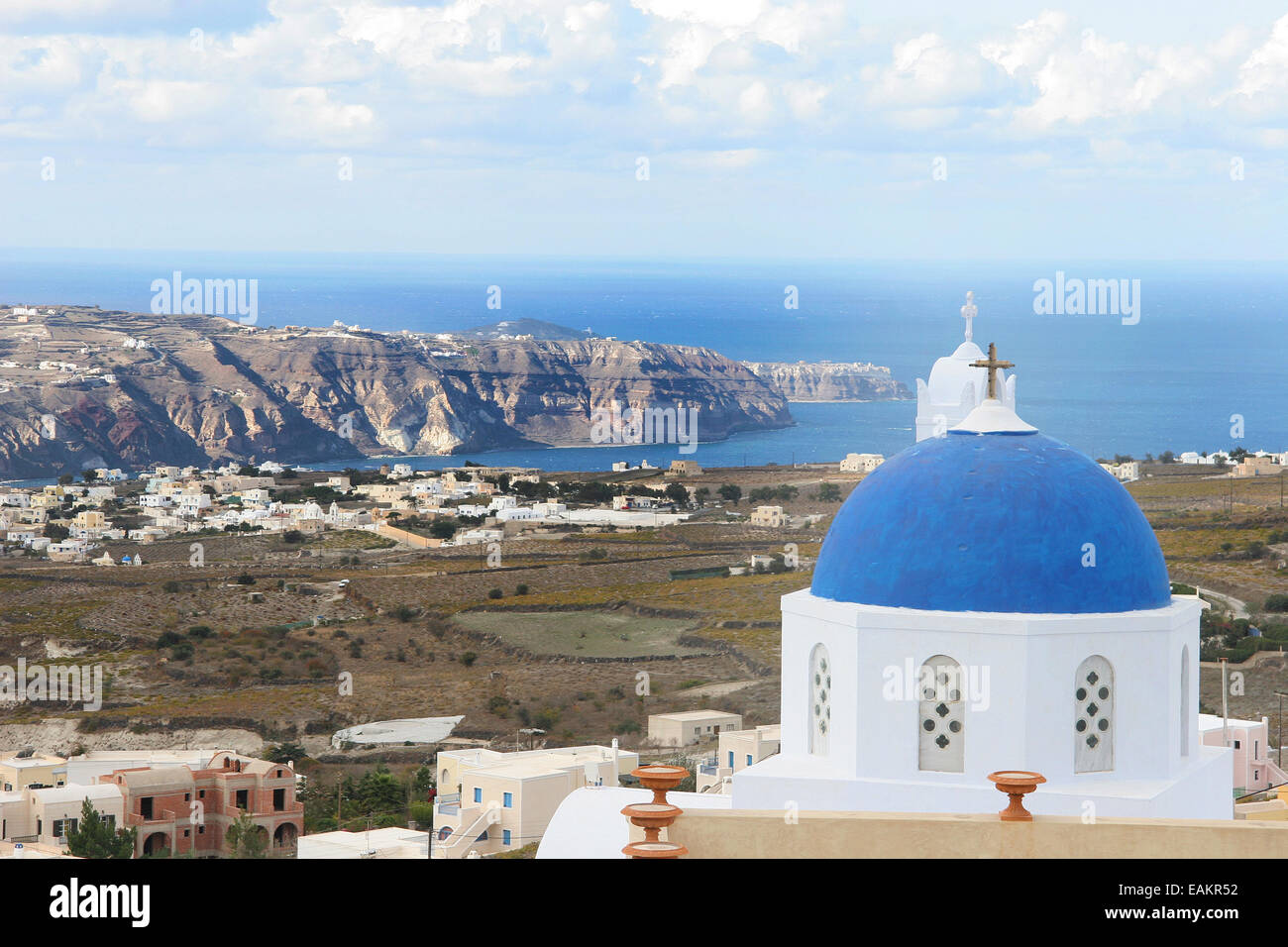 Traditional white church with a Blue dome, with island landscape behind ...