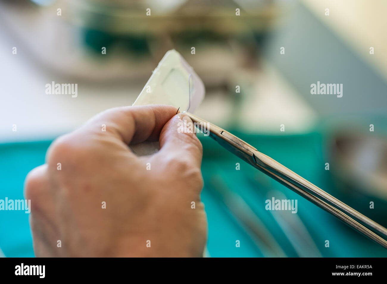 a surgeon opening the packed stitching thread Stock Photo - Alamy