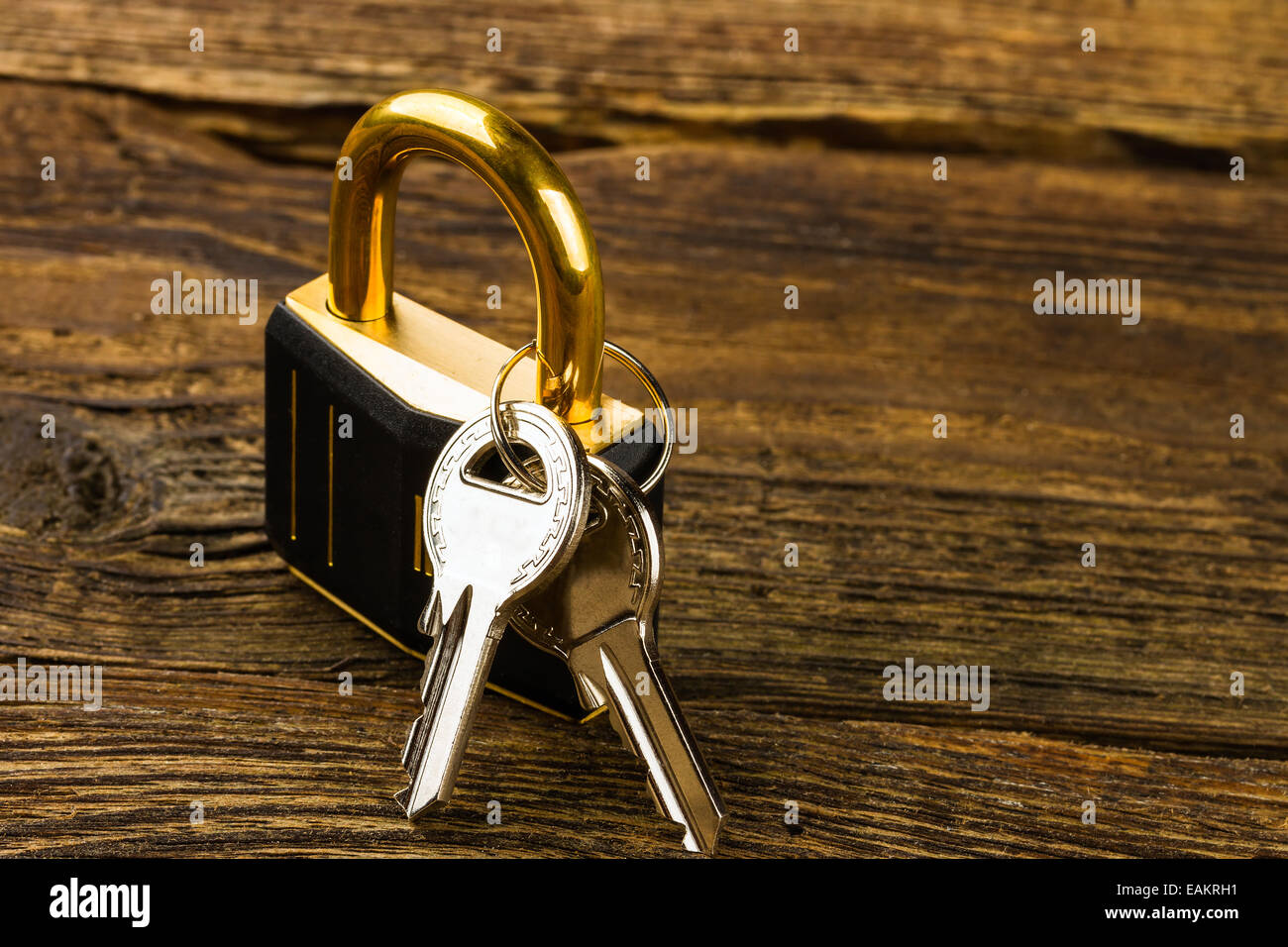 hinged lock with keys on wooden background Stock Photo - Alamy