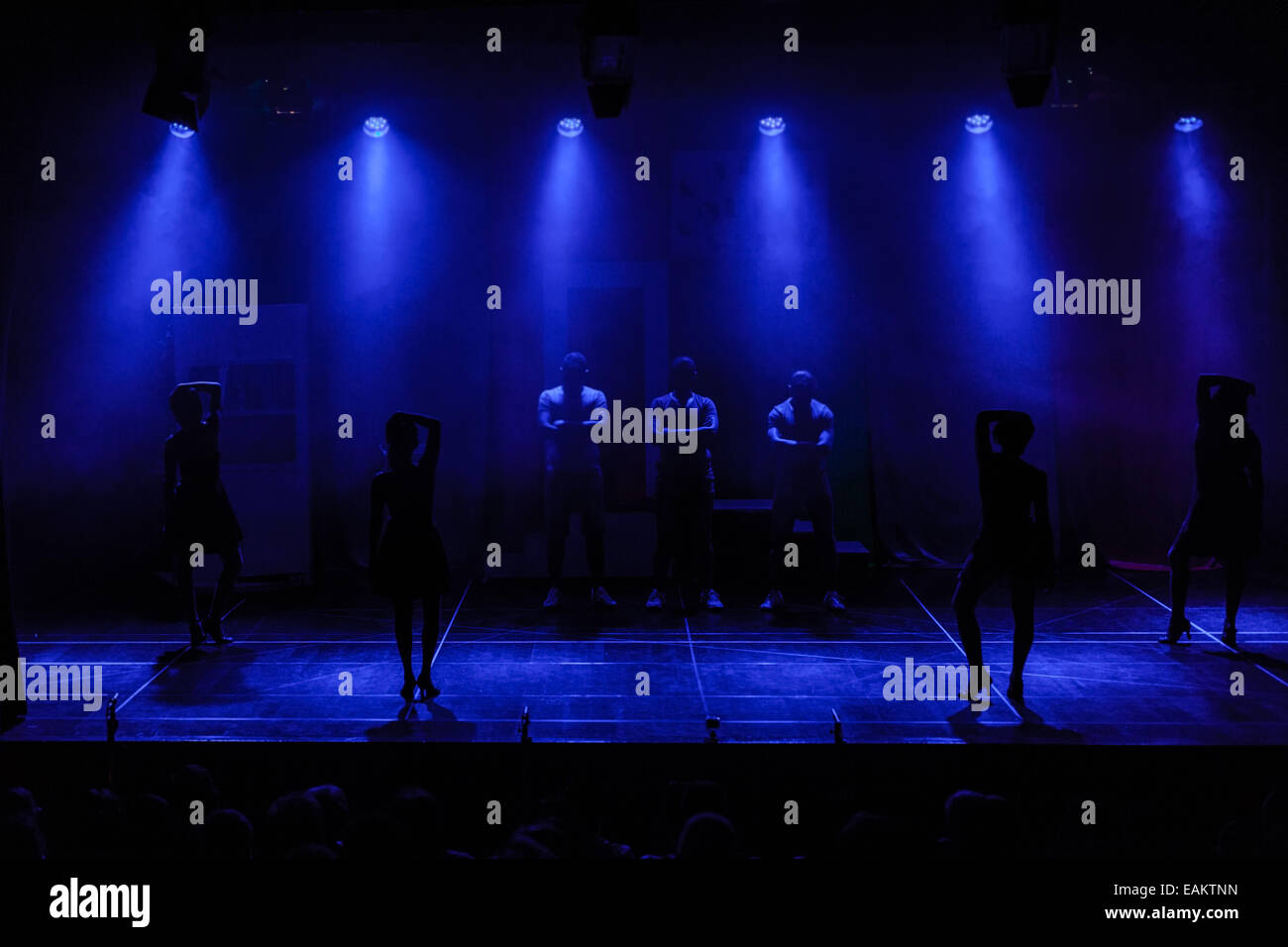 dancers on the stage with blue spot light and smoke Stock Photo - Alamy