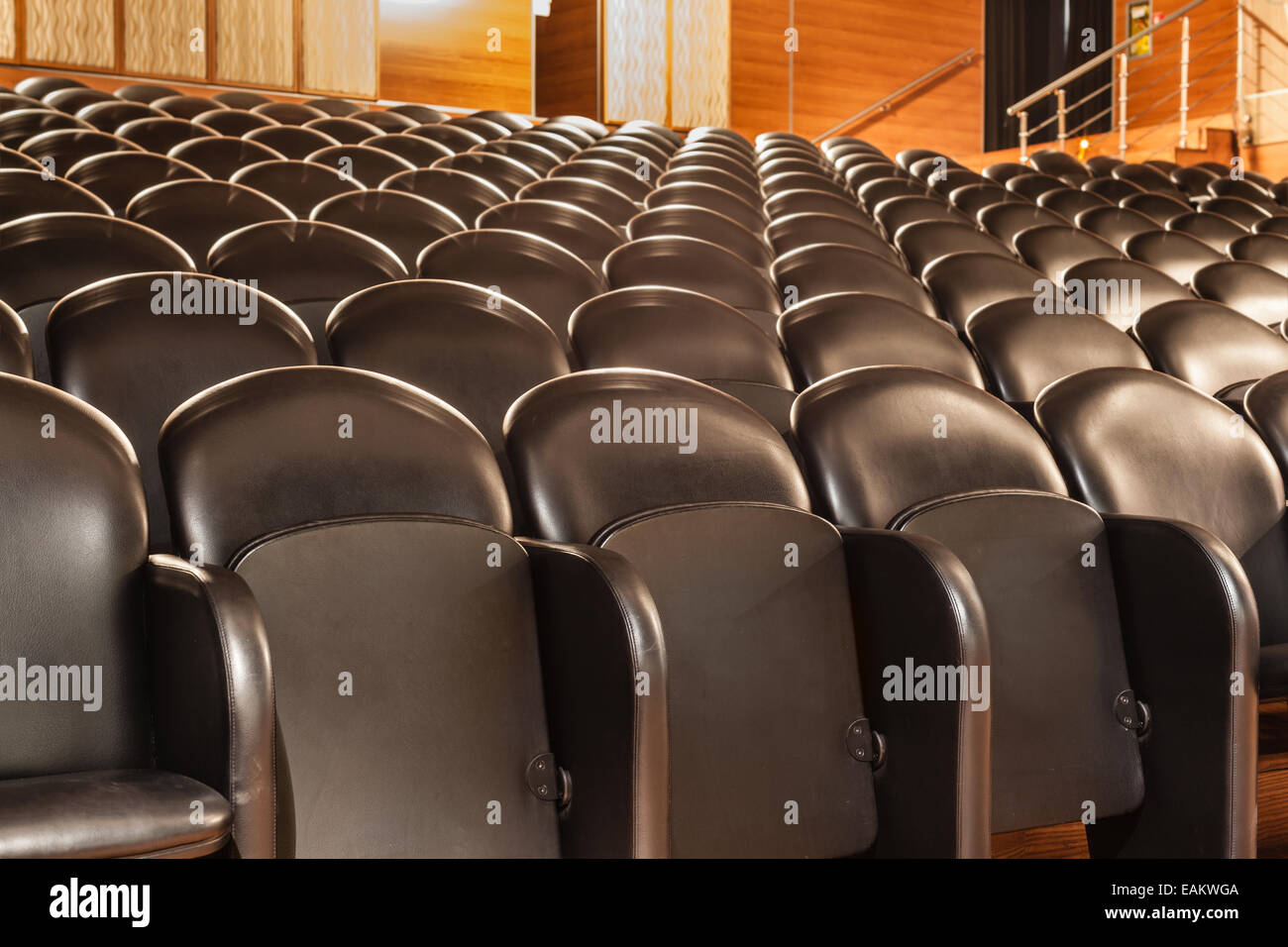 rows of black cozy chairs in a small theater Stock Photo - Alamy