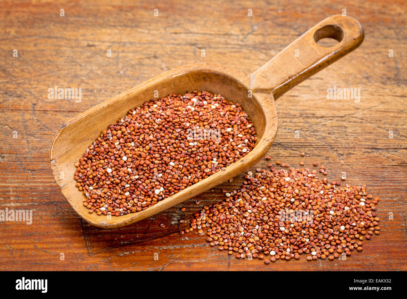 rustic scoop of red quinoa grain against grunge wood table Stock Photo ...