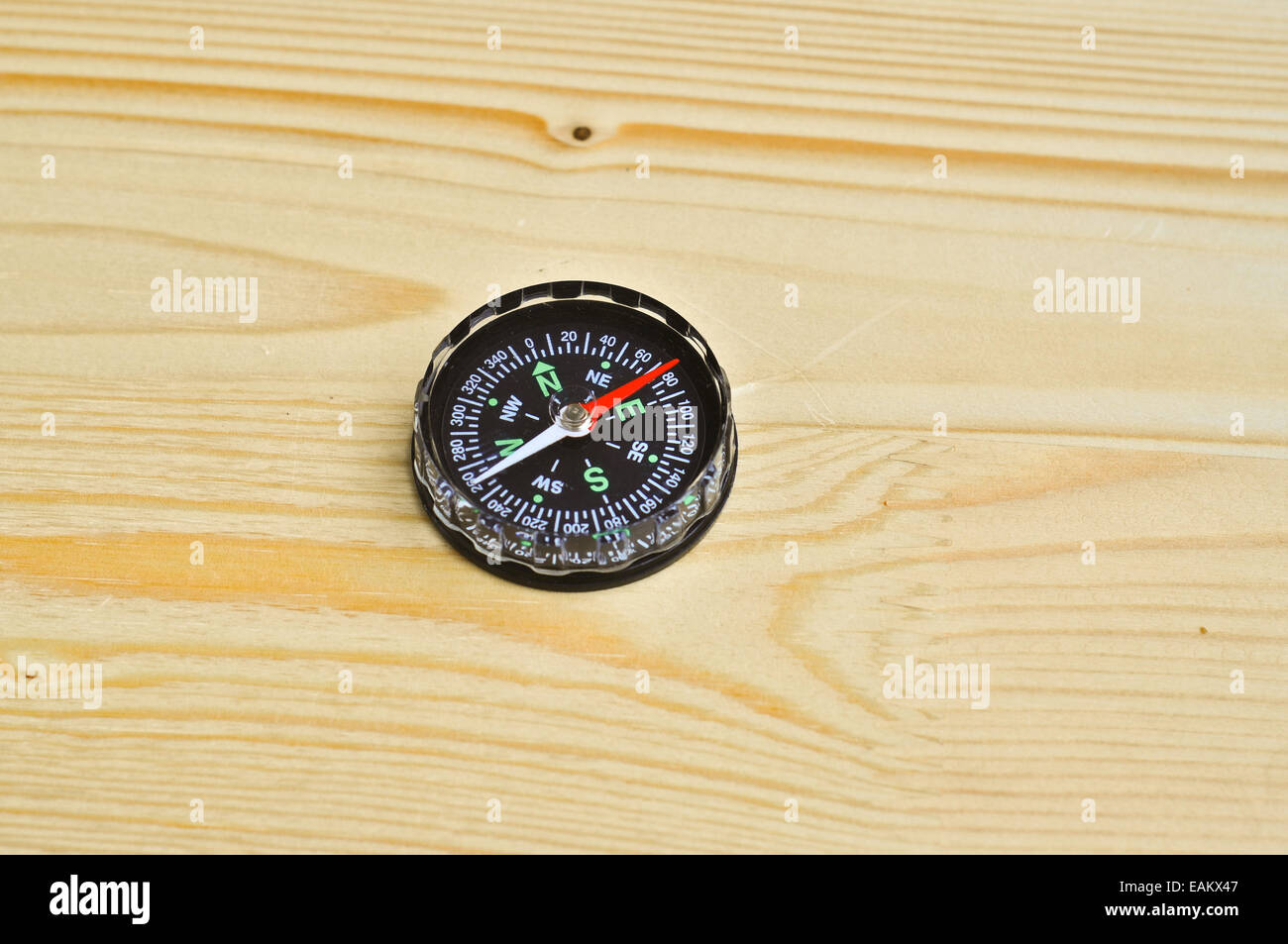 The compass on the Board. The magnetic compass lies on textured wood ...