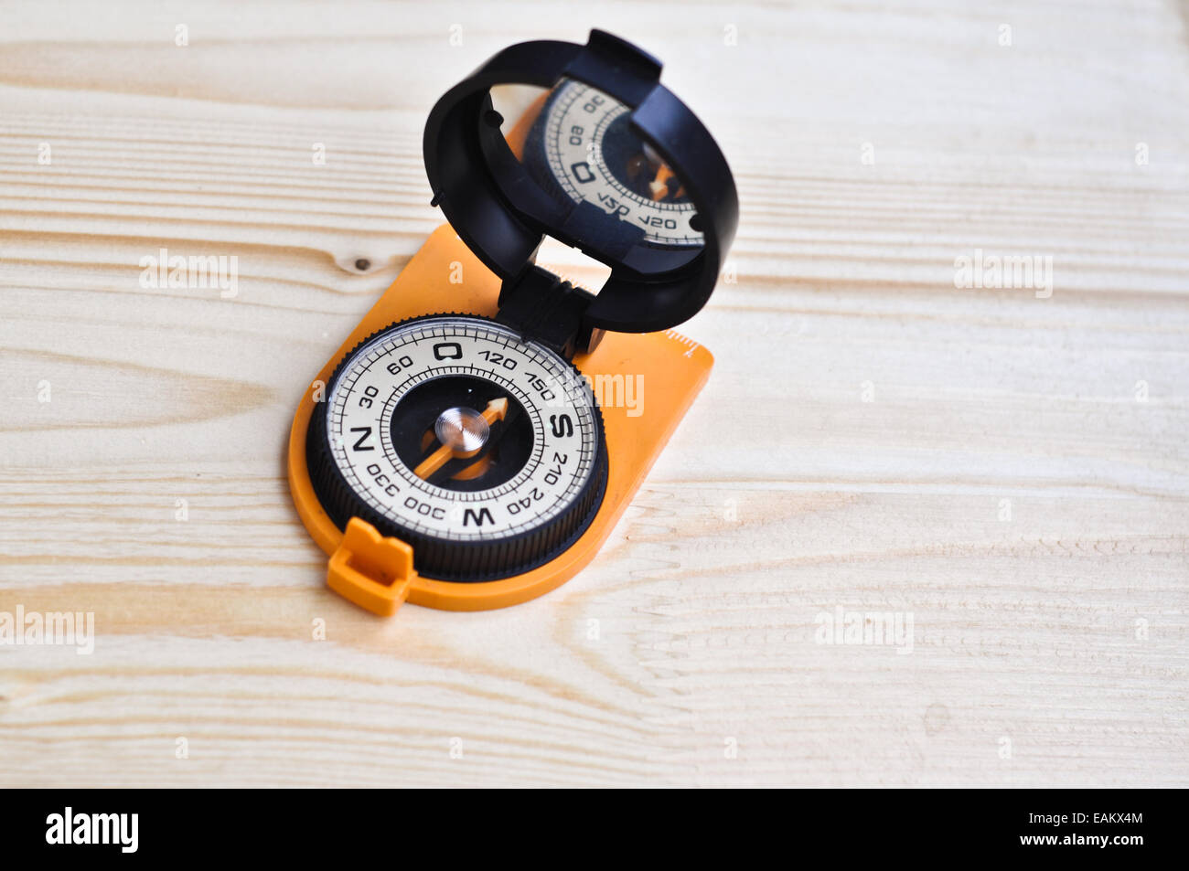 The compass on the Board. The magnetic compass lies on textured wood ...