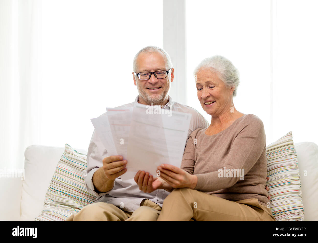 happy senior couple with papers at home Stock Photo - Alamy
