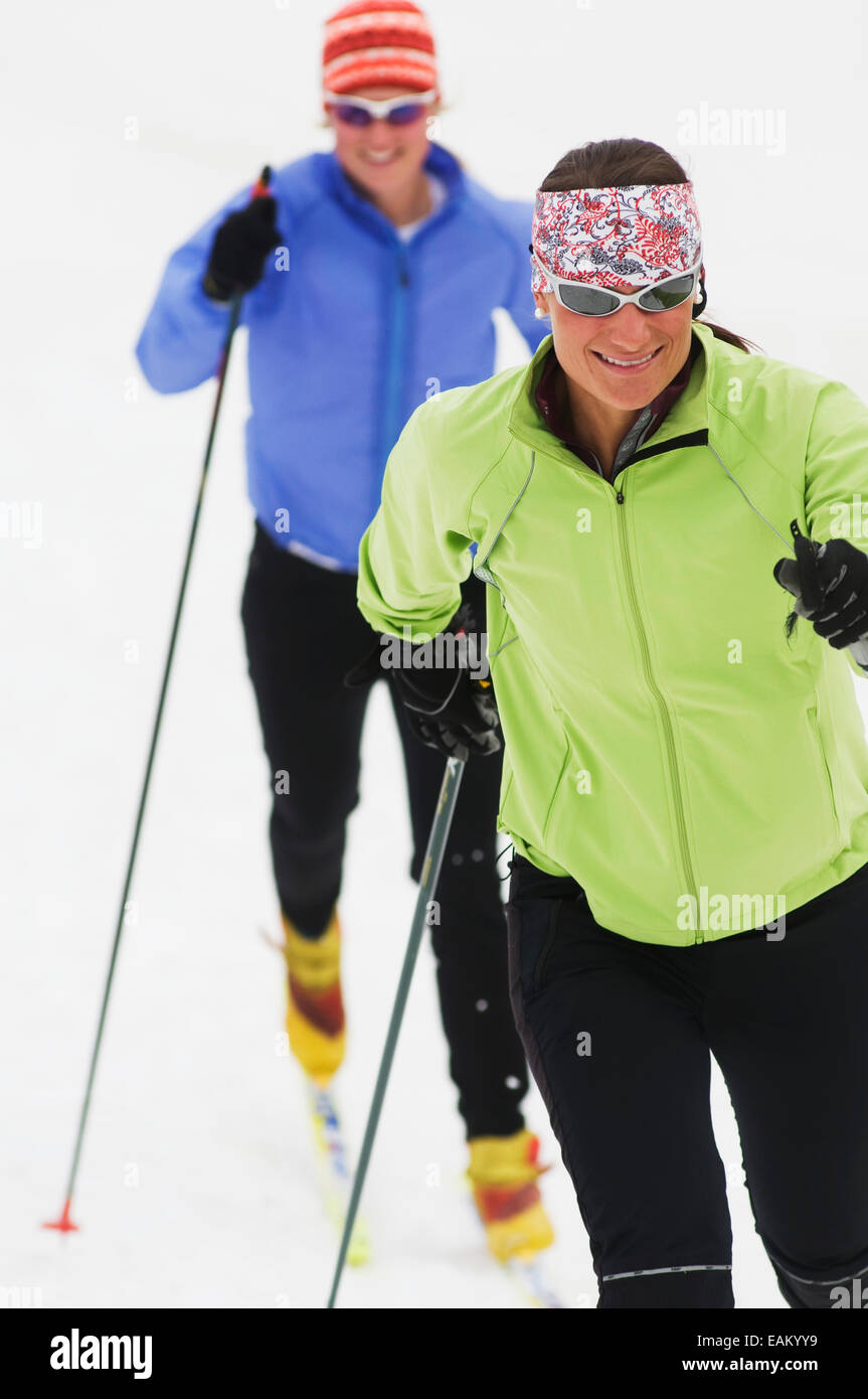 Two Young Women Cross Country Skiing Together At Glen Alps Area In ...