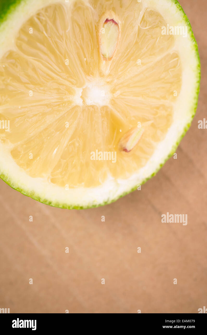 green lemon cut with seeds on a cardboard surface Stock Photo - Alamy