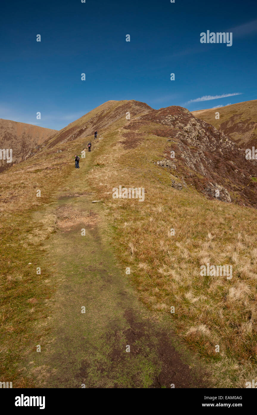 A young family travels along Whiteless Edge towards Wandope in the Lake ...