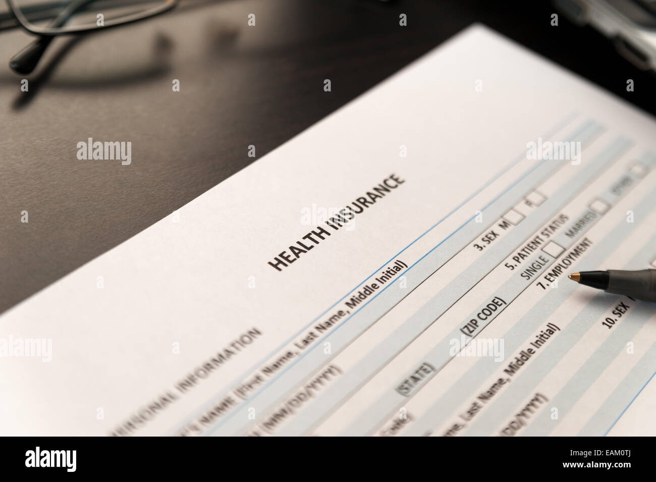 Filling health insurance application form Stock Photo - Alamy