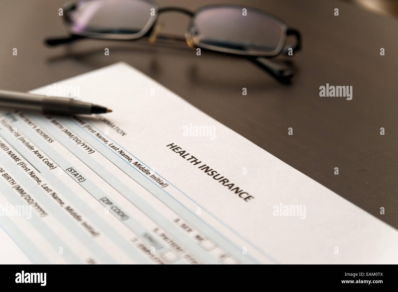 Filling health insurance application form Stock Photo - Alamy